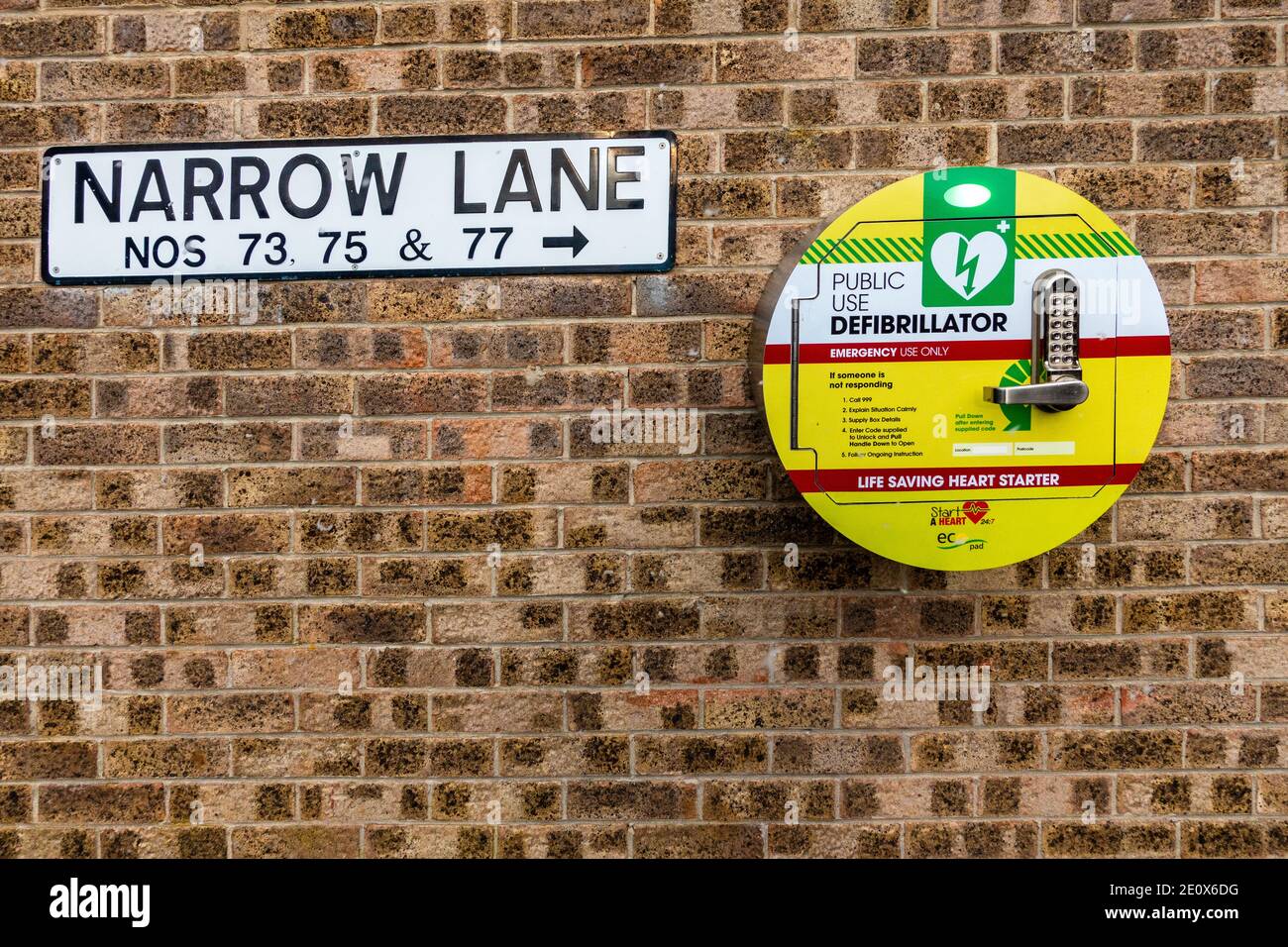 Public use emergency Defibrillator mounted on an exterior brick wall ...