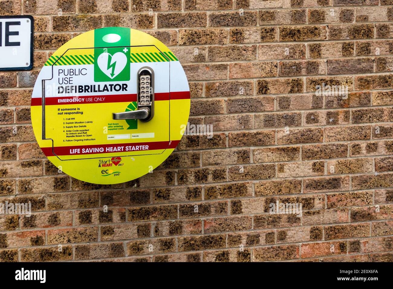 Public use emergency Defibrillator mounted on an exterior brick wall ...