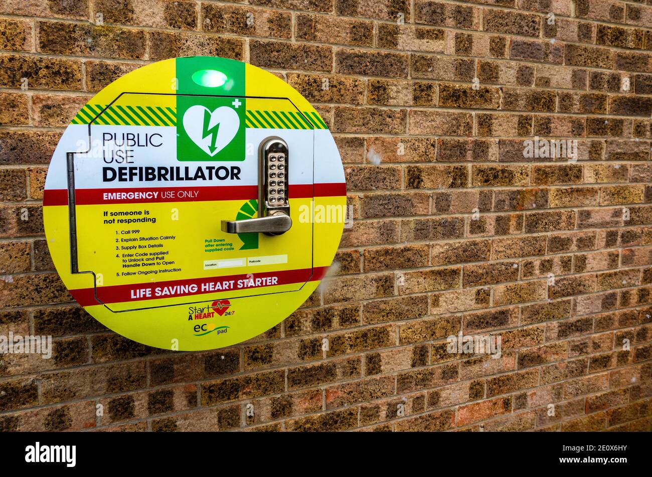 Public use emergency Defibrillator mounted on an exterior brick wall ...