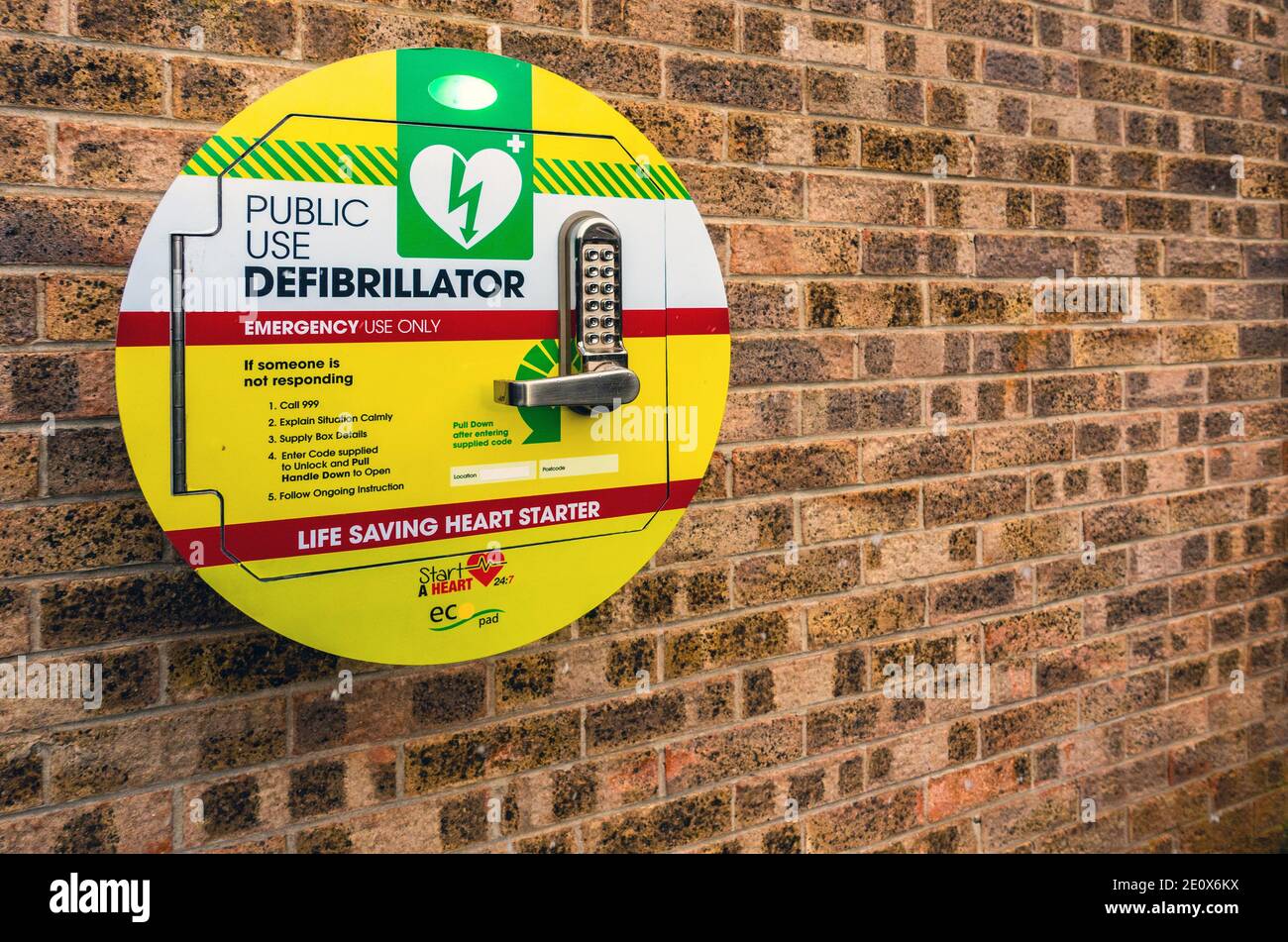 Public use emergency Defibrillator mounted on an exterior brick wall ...