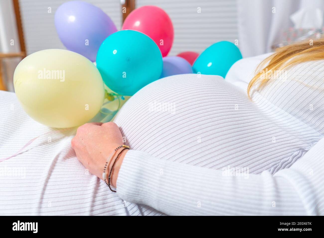 Pregnant woman belly and balloons isolated on white. Pregnancy concept ...