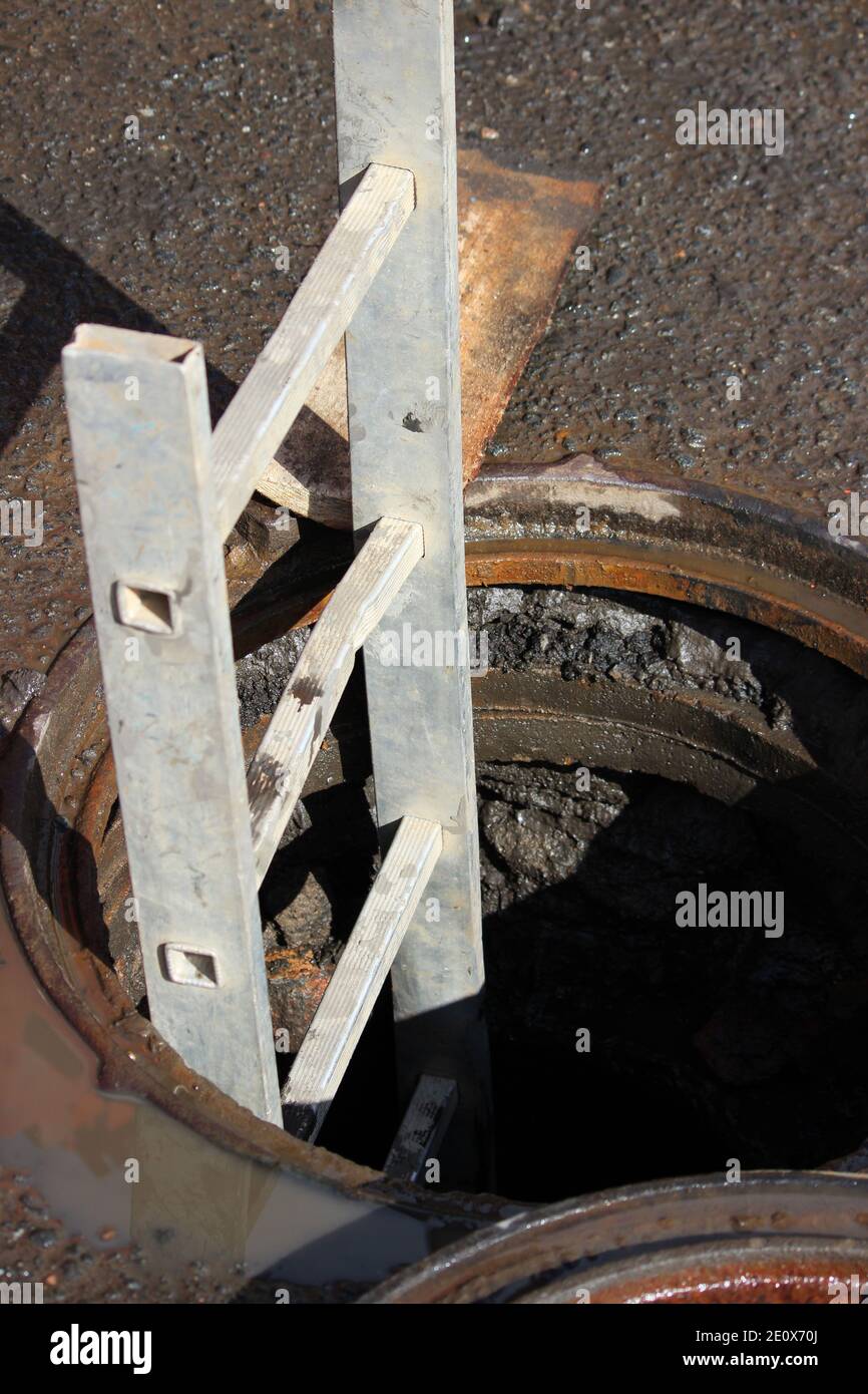 staircase and open hatch. Repair work on sewage pipes Stock Photo - Alamy