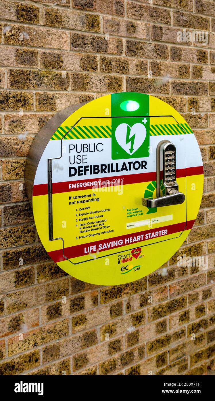 Public use emergency Defibrillator mounted on an exterior brick wall ...
