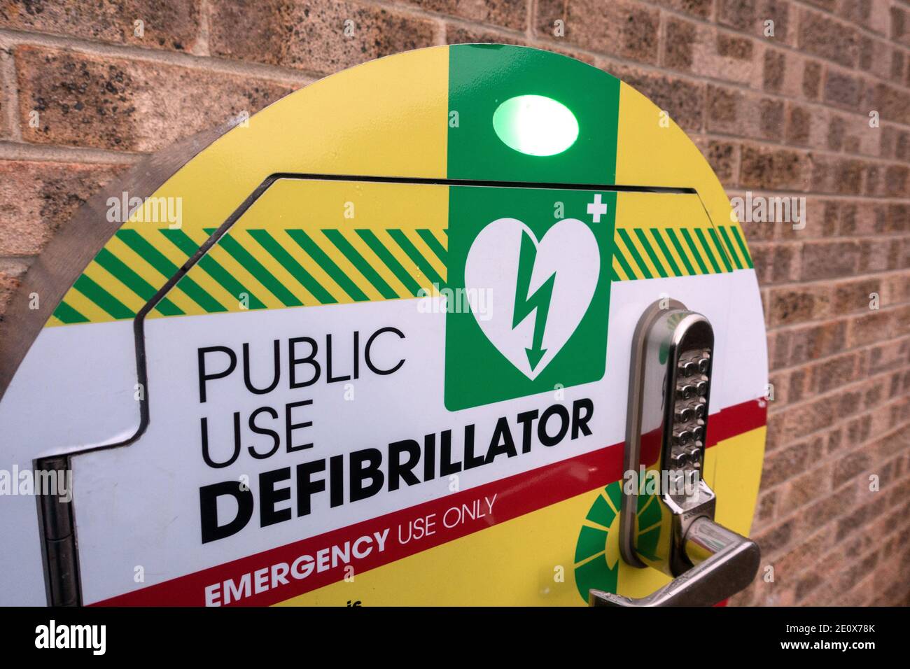 Public use emergency Defibrillator mounted on an exterior brick wall ...