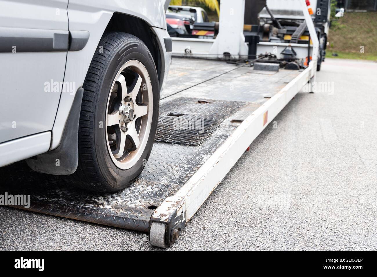 Cable attached to broken down car being pulled onto tow truck Stock ...
