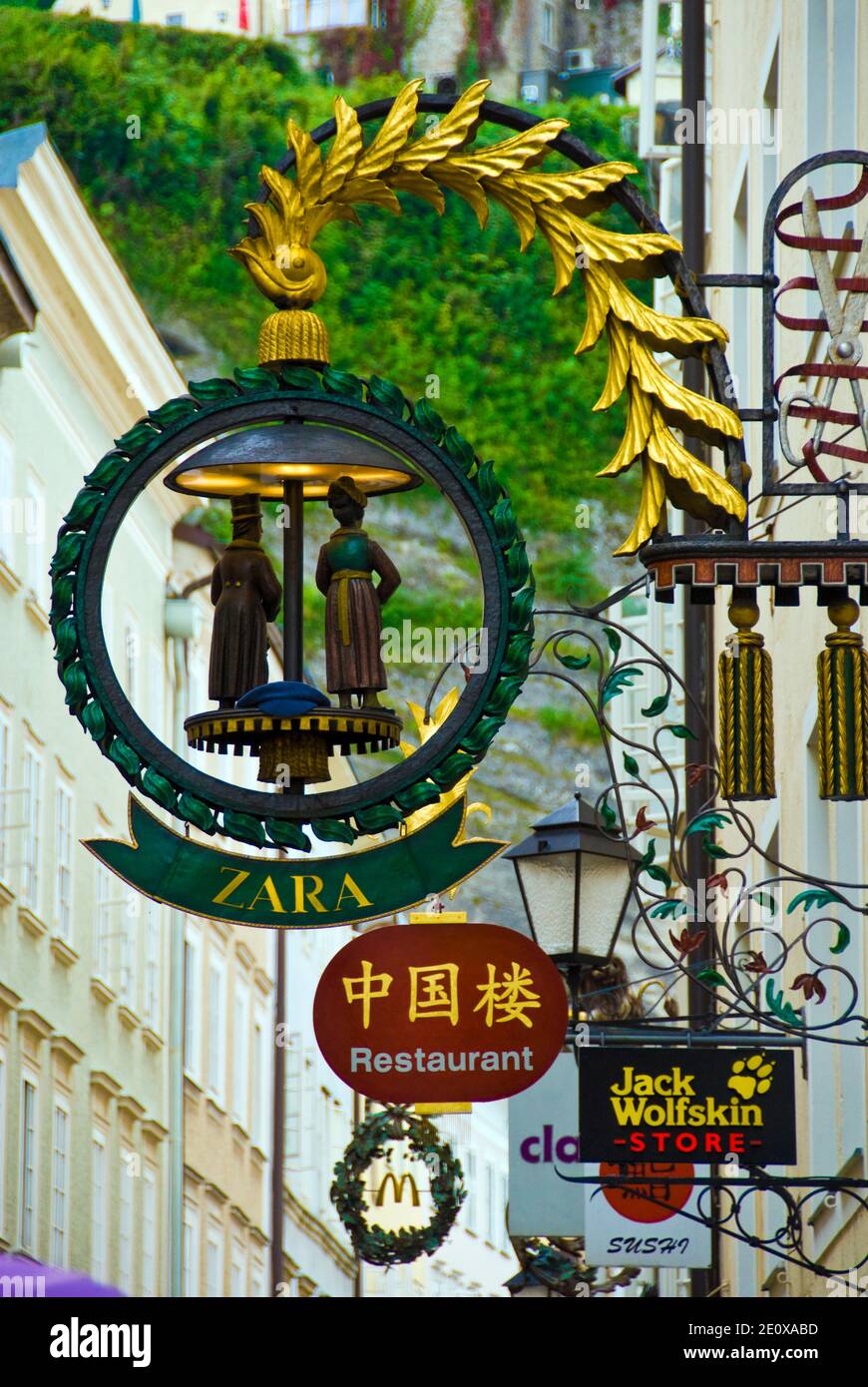 Traditional iron painted signs for businesses on a shopping street in ...