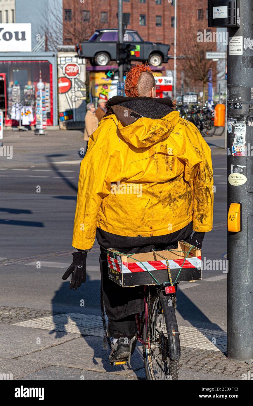 Cyclist With Dirty Yellow Jacket In Berlin Stock Photo - Alamy