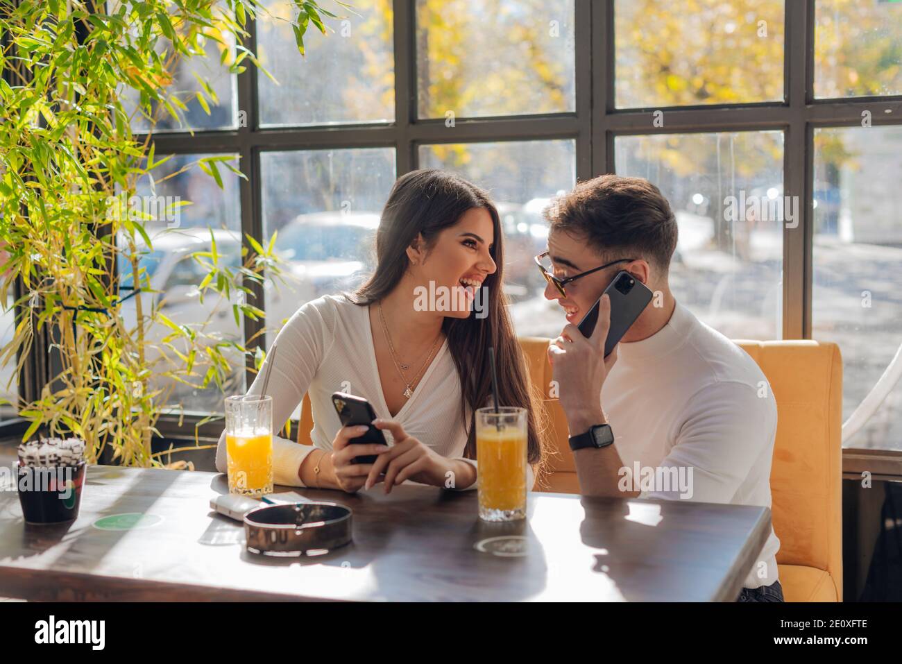 Friends socializing, having fun, and laughing drinking coffee in ...