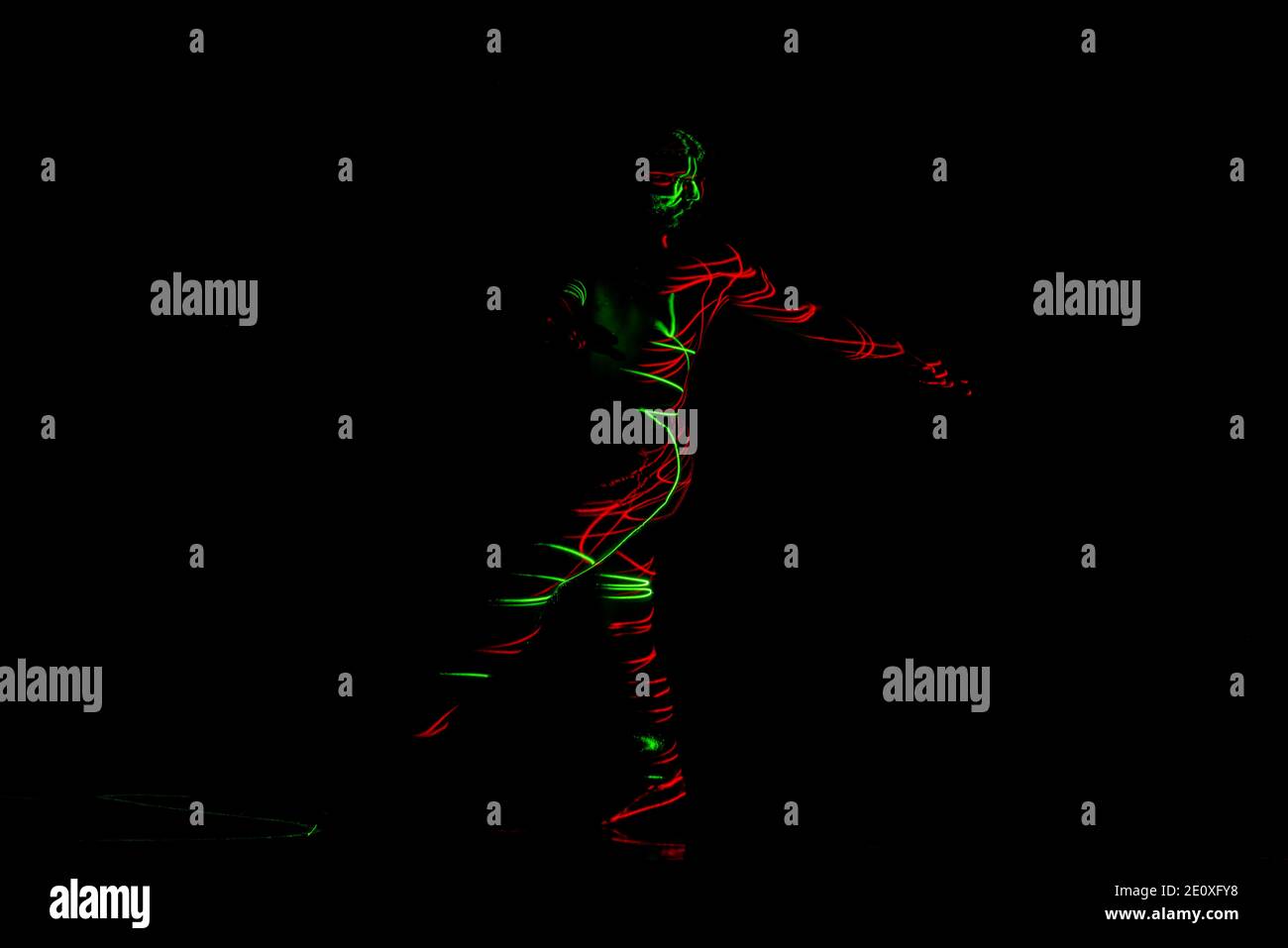 Laser beams outline of a dance artist performing an elegant dance ...