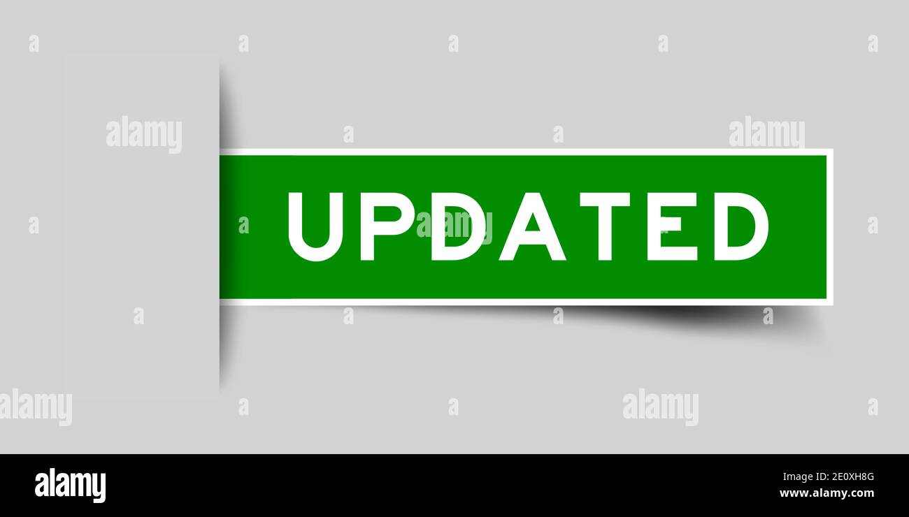 Inserted green color sticker label with word updated on gray background ...