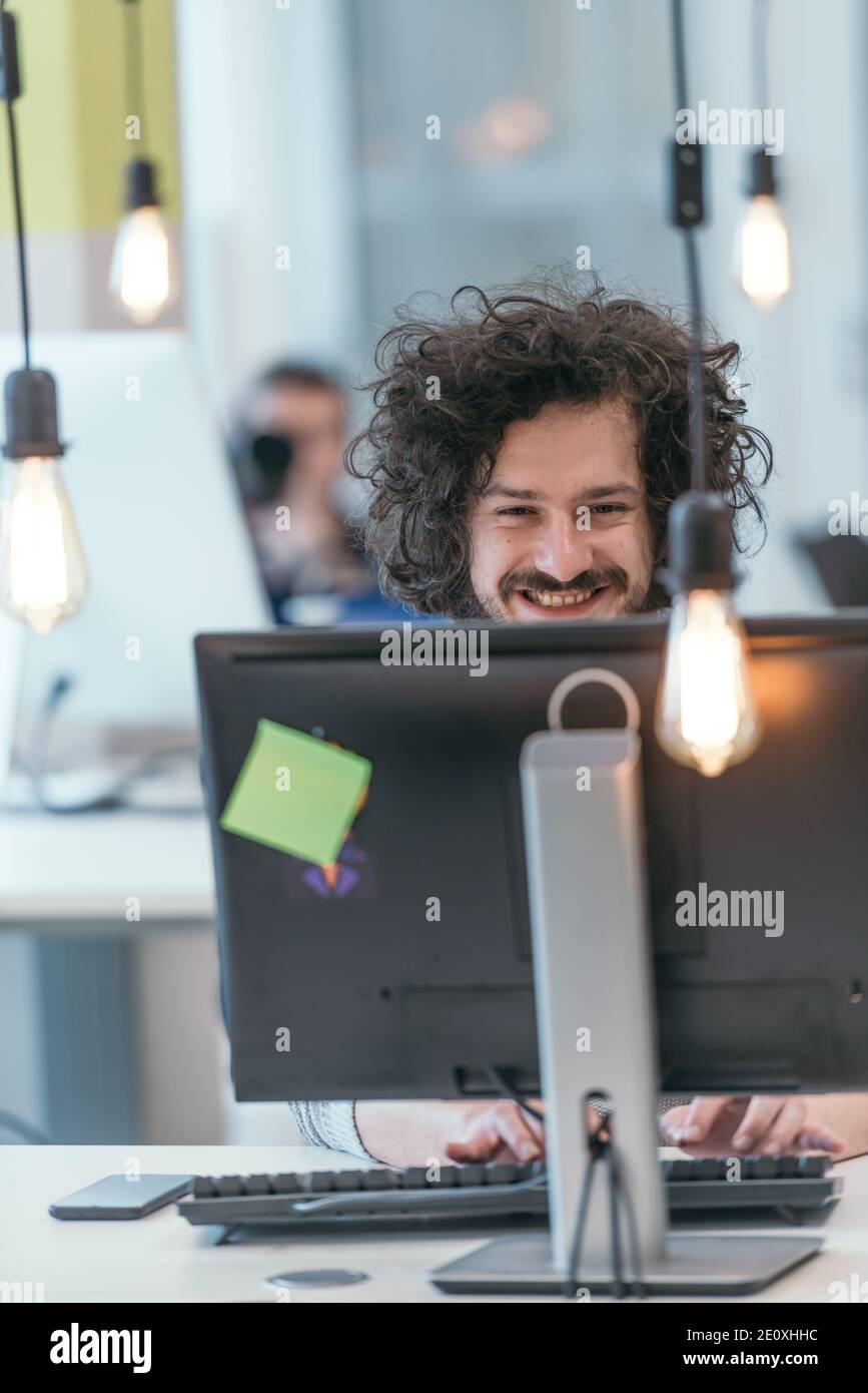 Portrait of pretty cheerful accountant looking at the camera sitting at ...