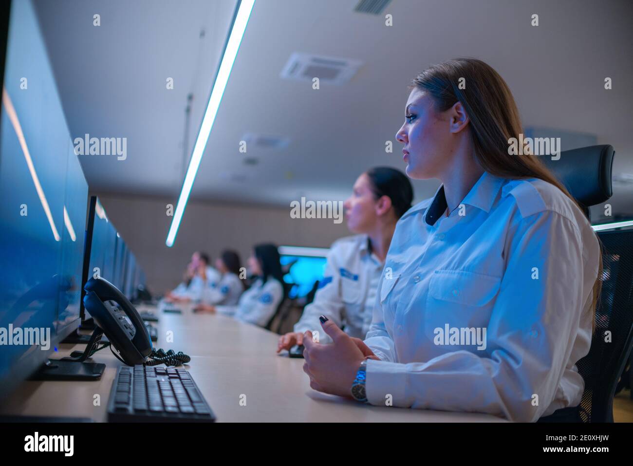 Close up photo of a security female agent monitoring the CCTV in a main ...