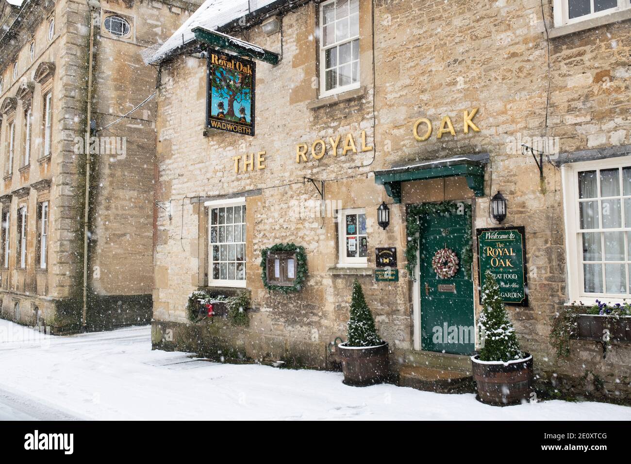 The Royal Oak pub in the snow in Witney street at christmas. Burford ...