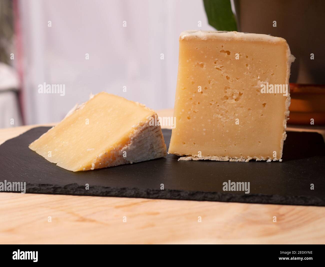 Two Pieces Of Matured Cheese On A Tray Stock Photo - Alamy