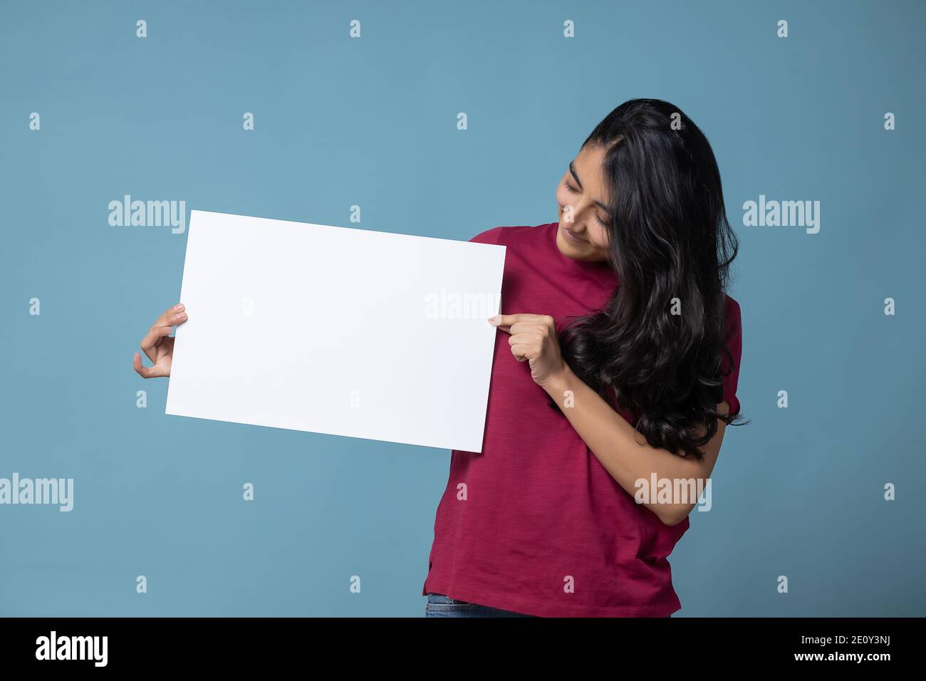 Mexican latin young adult woman holding a blank peace of paper Stock ...