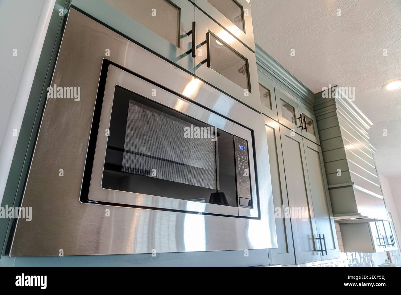 Built in microwave oven and wall cabinets inside the clean kitchen of ...