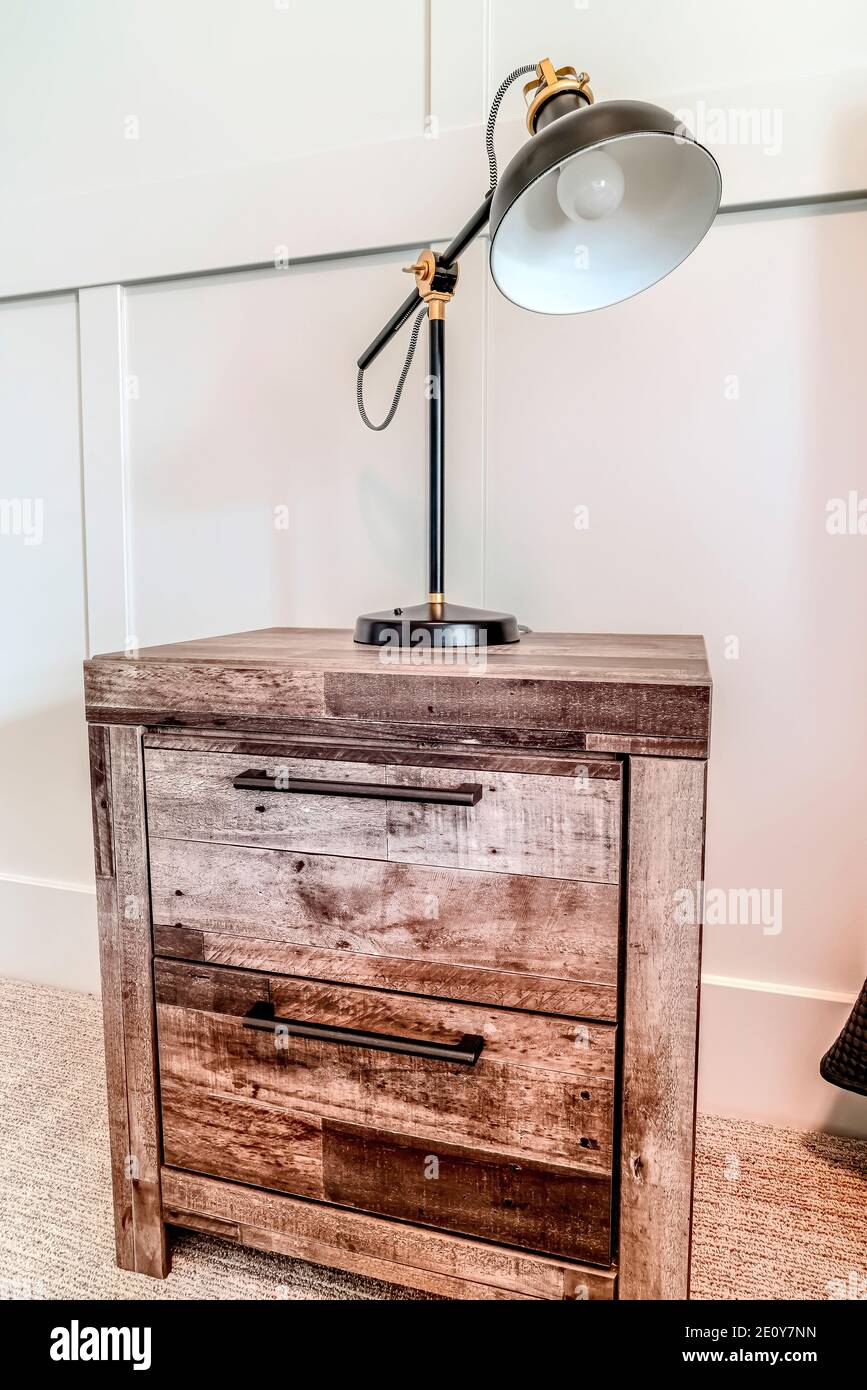 Portable lamp with swing arm design on the side table cabinet of ...