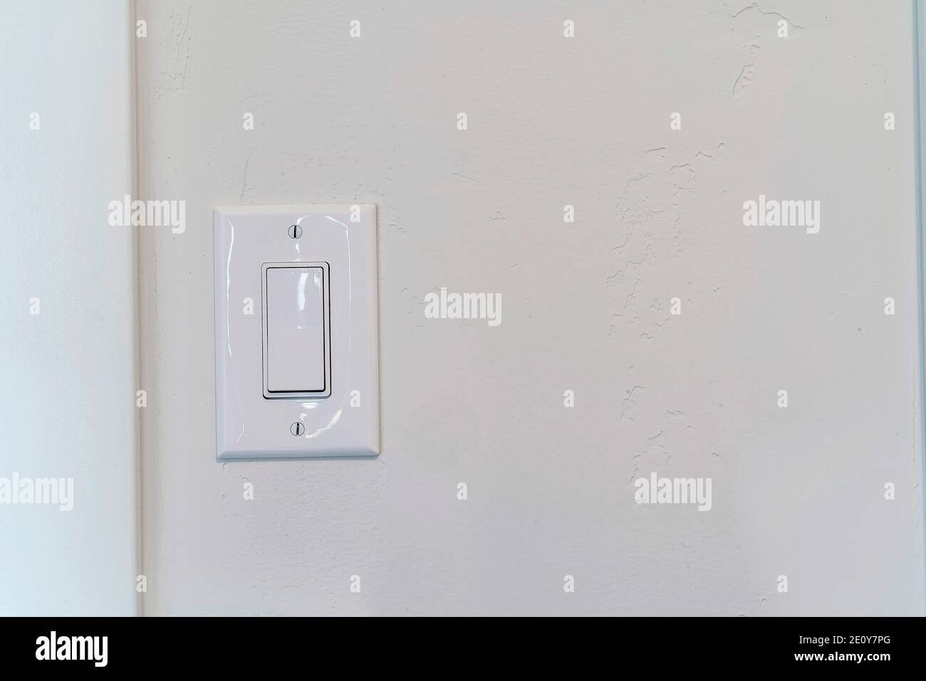 White wall with electrical rocker light switch inside the room of a ...