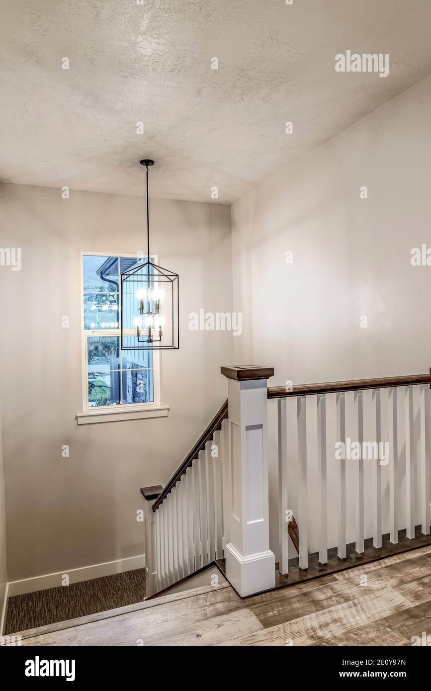 Staircase inside home with wooden handrail and balusters and U shape ...