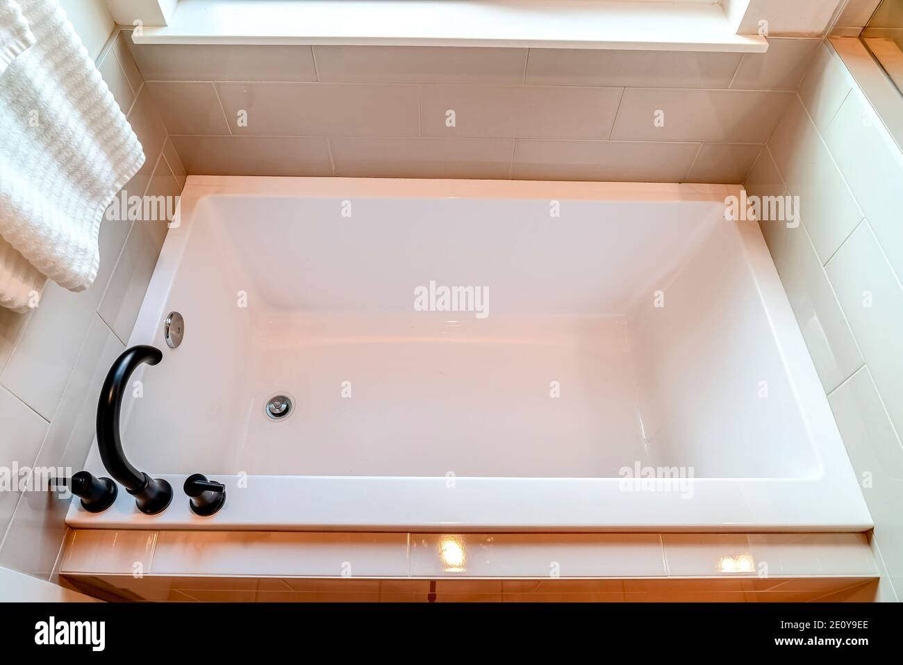 Top view of a built in rectangular bathtub inside the clean bathroom of ...