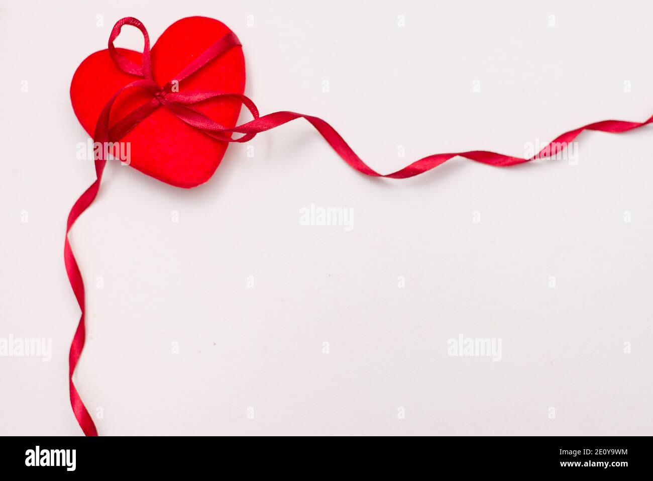 Heart with red ribbon. Isolated on white background Stock Photo - Alamy