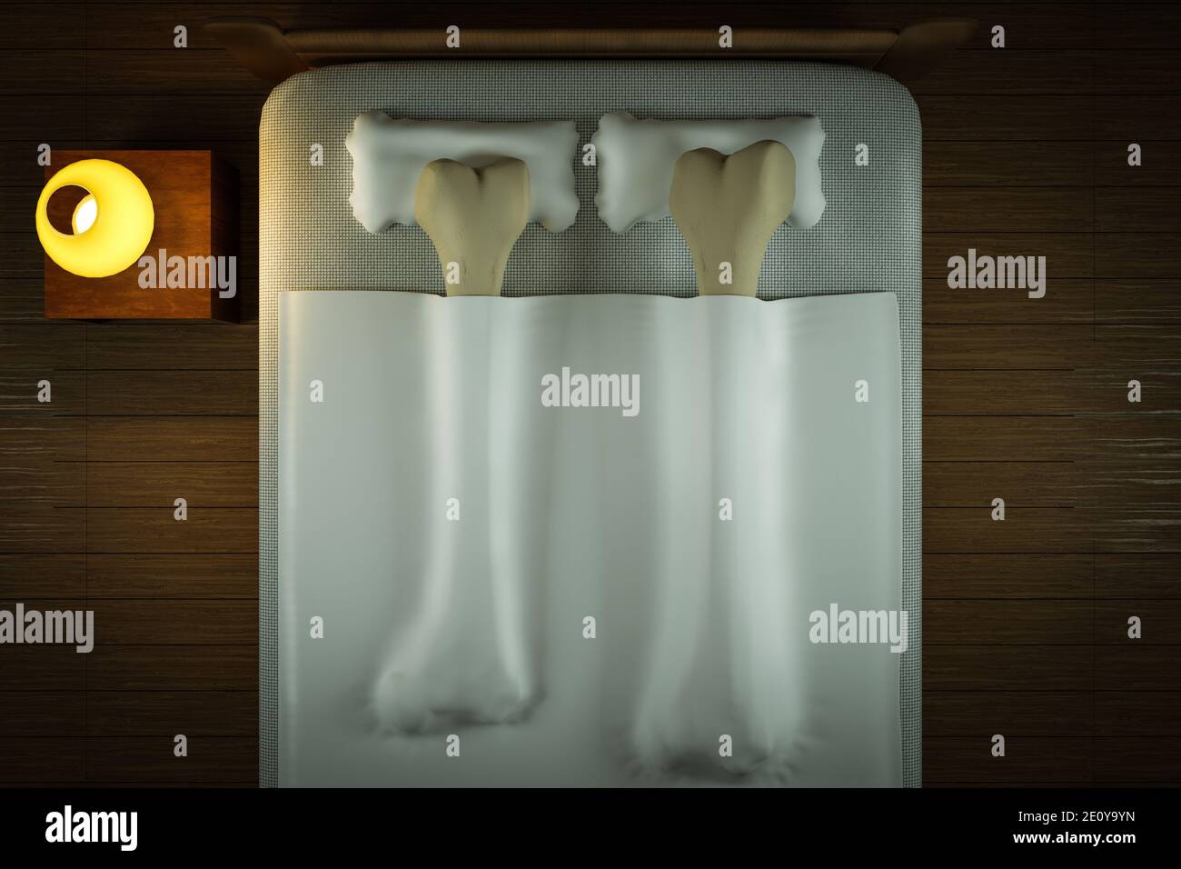 Top view of two human thigh bones in bed before sleep with a yellow ...