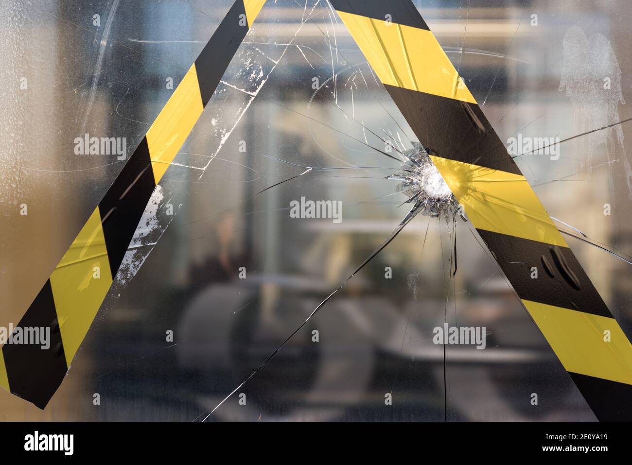 Barrier tape and a broken window in the city Stock Photo - Alamy