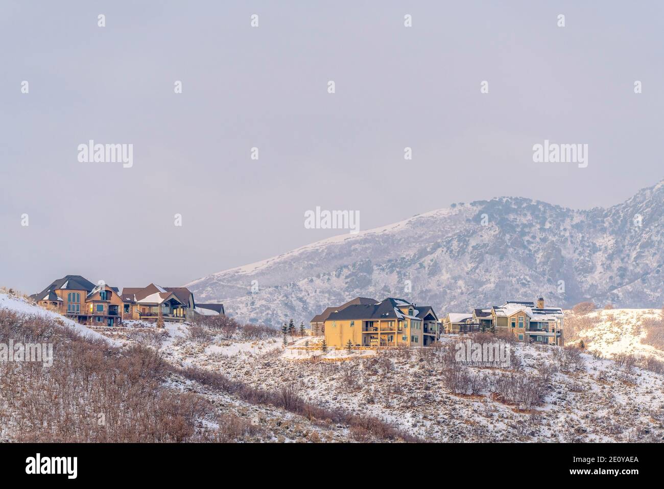 Nature and residential landscape on a snowy winter day with cloudy sky ...