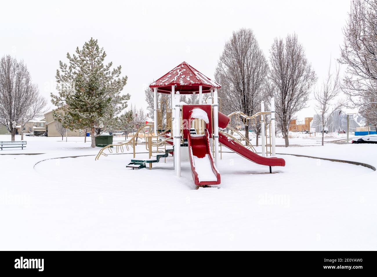 Park on neighborhood with colorful childrens playground on snowy winter ...