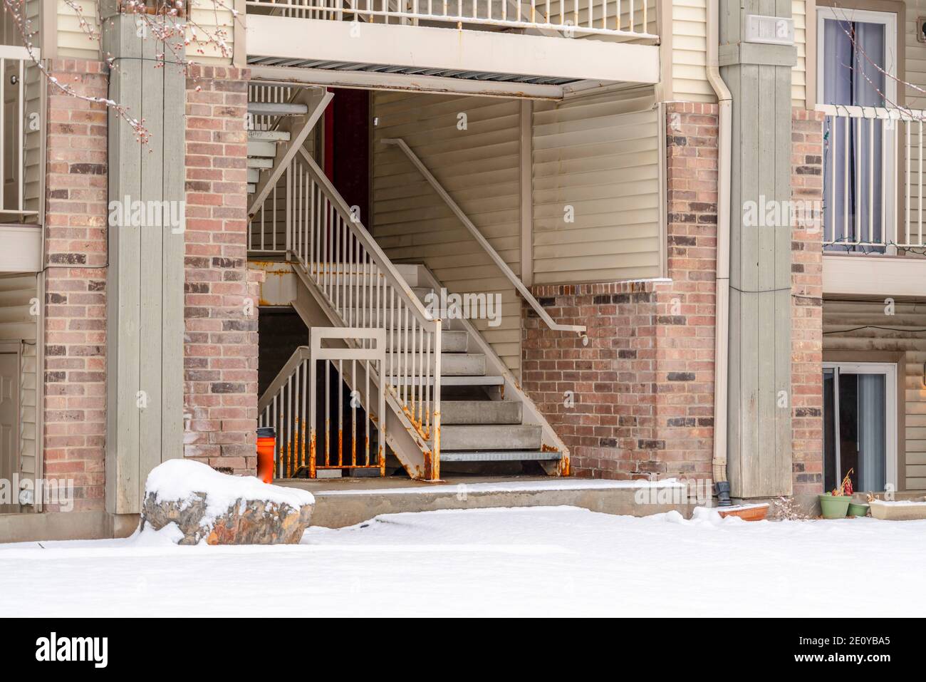 Flight of stairs at the residential building entrance with snowy yard ...
