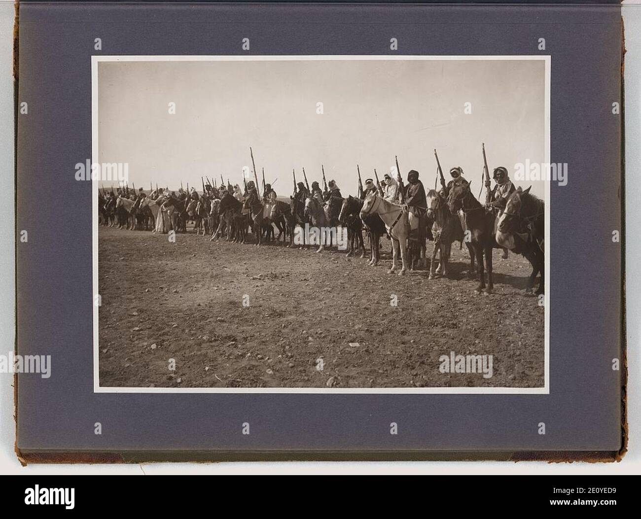 Line of Bedouin men with rifles on horseback Stock Photo - Alamy