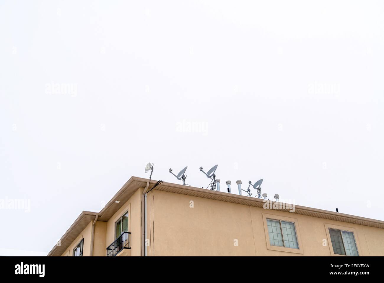 Residential building with parabolic satellite dishes installed on the ...