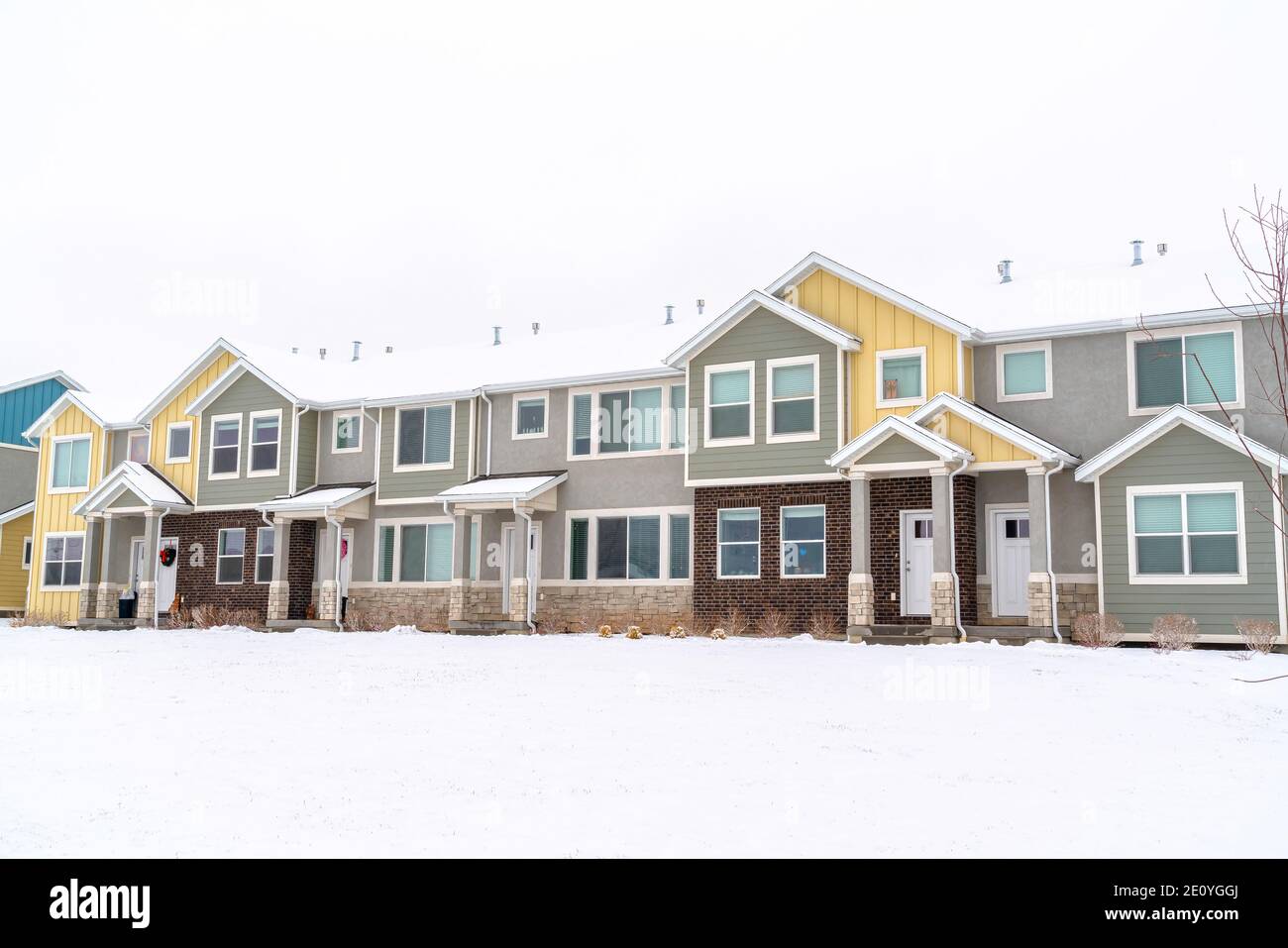 Apartment houses in a snowy neighborhood with cloudy sky background in ...