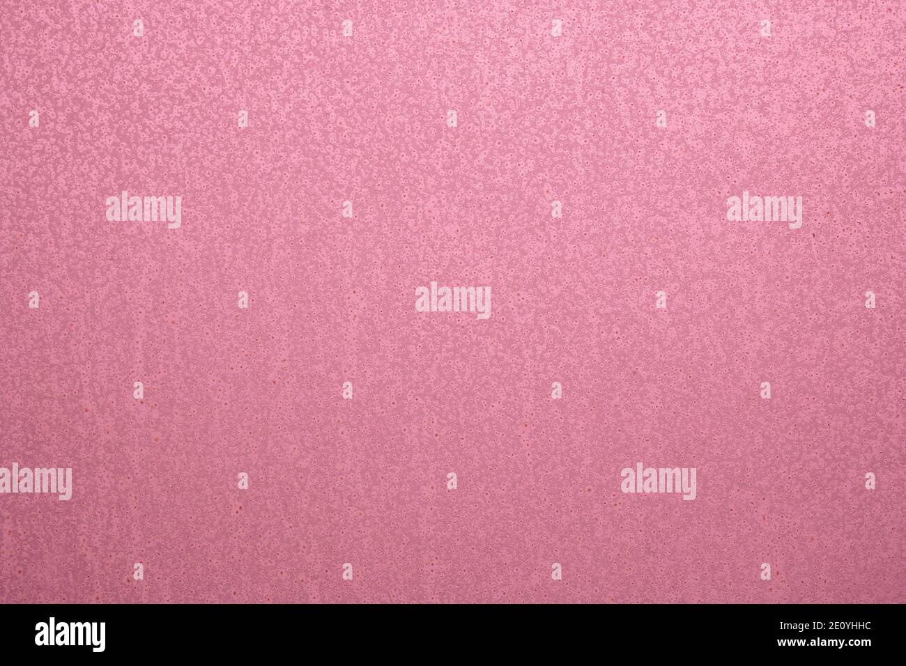 Abstract pink background. An empty, flat surface with a fine texture ...