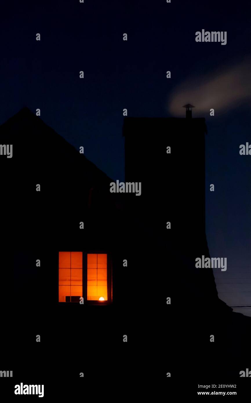 Light from the window of the house in the dark evening time Stock Photo ...