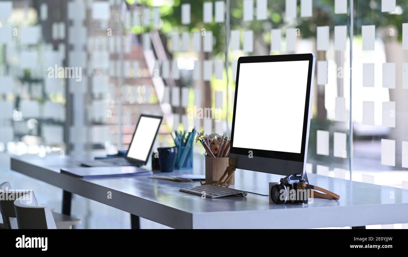 Side view of photographer workstation with modern multiple devices ...