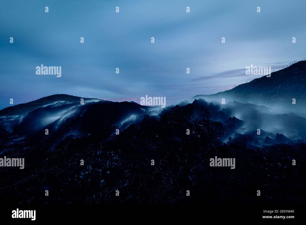 Smoke rising from volcano at night Stock Photo - Alamy