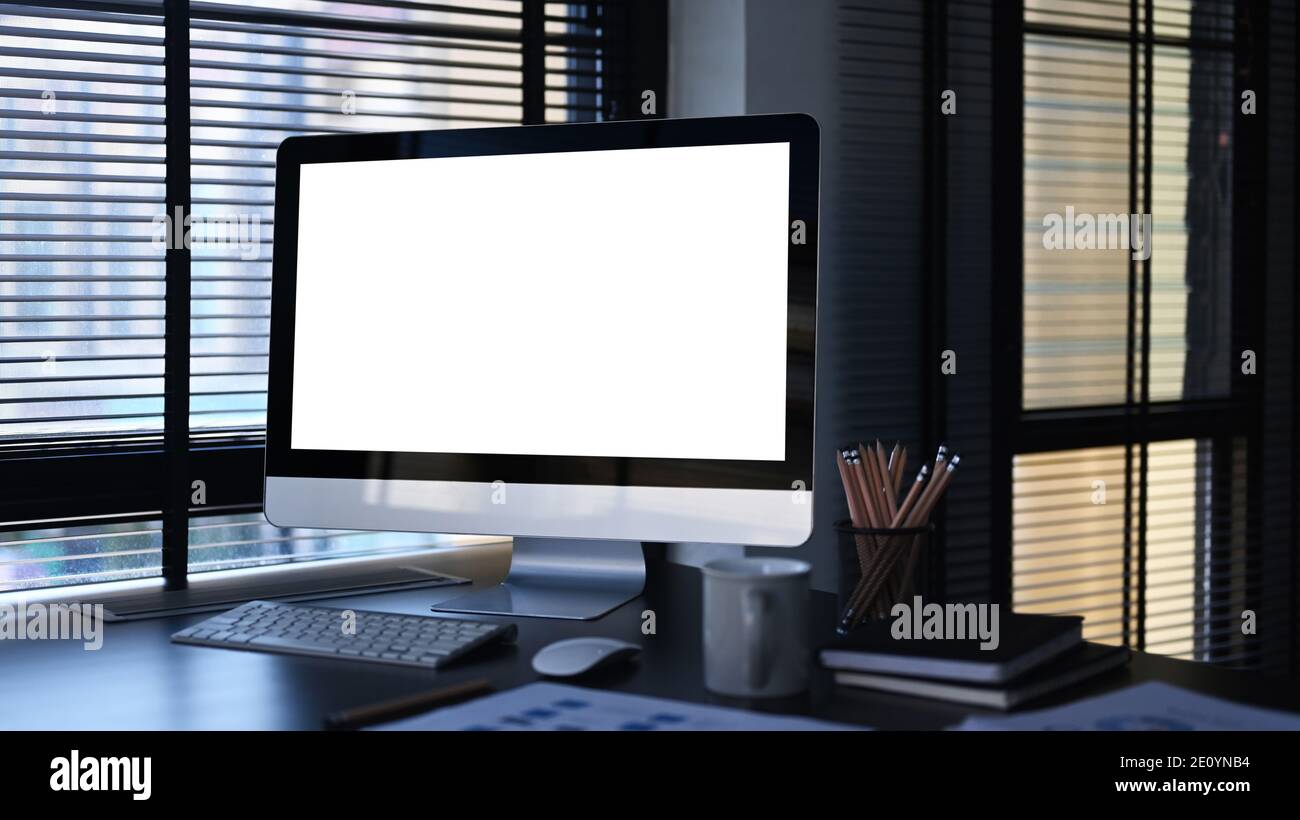 Executive work desk with computer at modern office. Blank screen ...