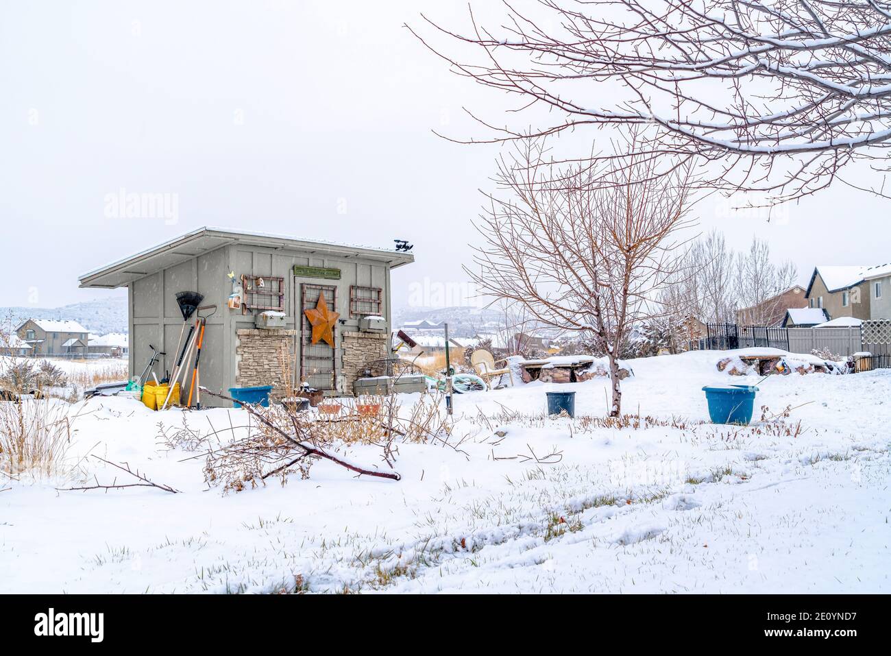 Roofed storage shed with single door on a landscape with snow at winter ...