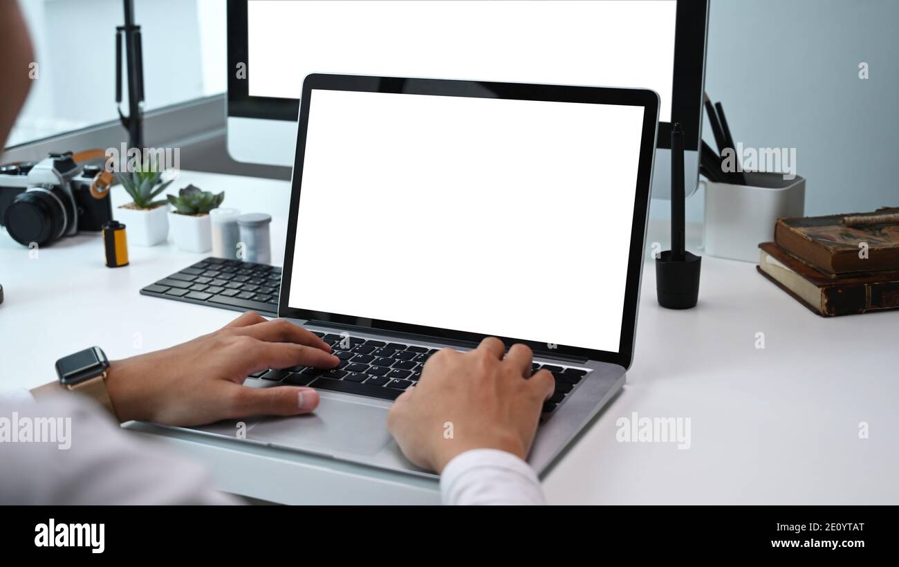 Rear view of photographer or graphic designer working with multiple ...