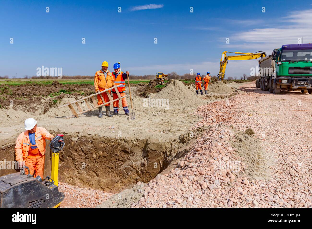 Worker is compacting gravel with vibration plate compactor machine in ...