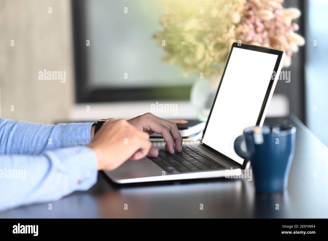 Side view man hands typing on keyboard of mock up laptop computer with ...