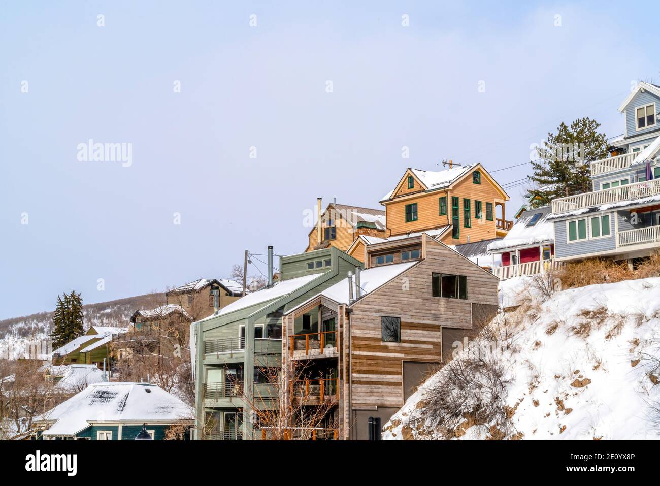 Residential landscape of homes built on mountain community with snowy ...