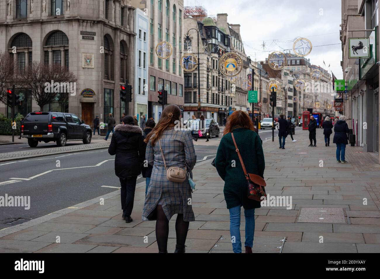 Rear view of two women walking down the Strand, London, Britain ...