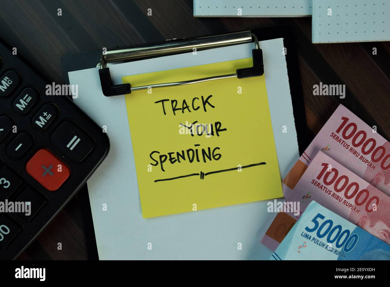 Track Your Spending write on sticky notes with indonesian currency ...