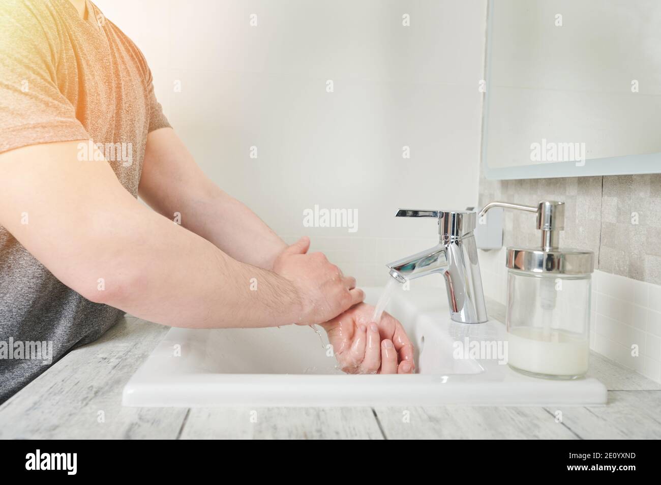 Man washing his wrist under sink in modern bathroom Stock Photo - Alamy