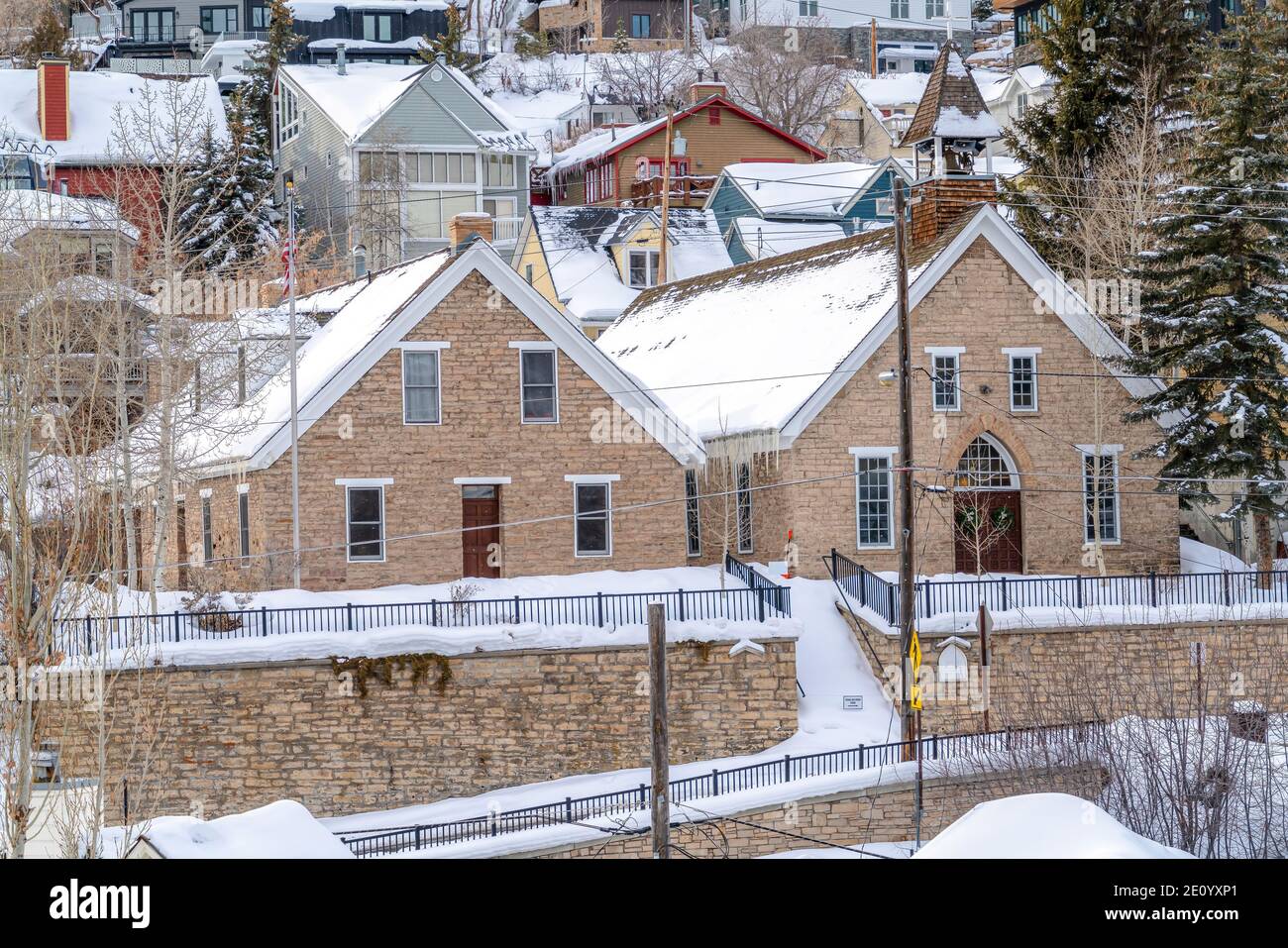 Church and houses on a residential community in the snowy mountains in ...