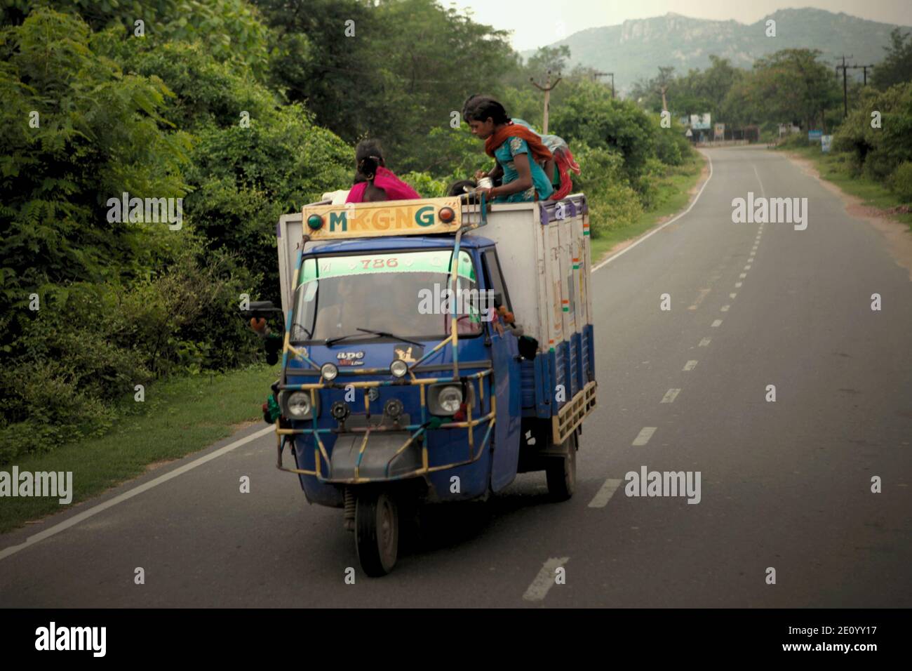 A modified auto-rickshaw carrying passengers in Rajgir, Bihar, India ...