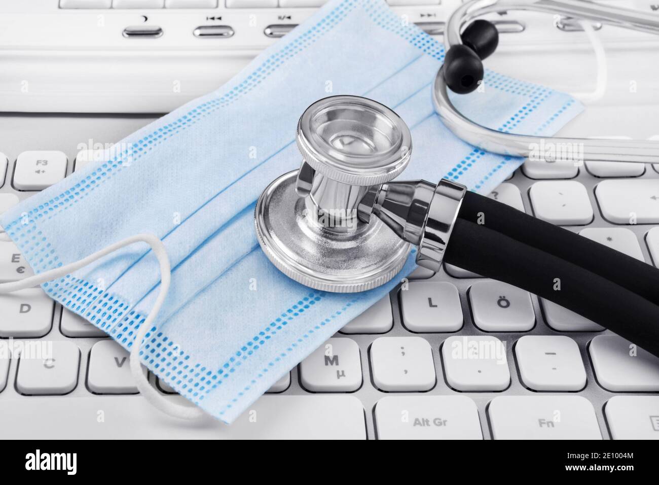 Face mask and stethoscope with PC keyboard Stock Photo - Alamy