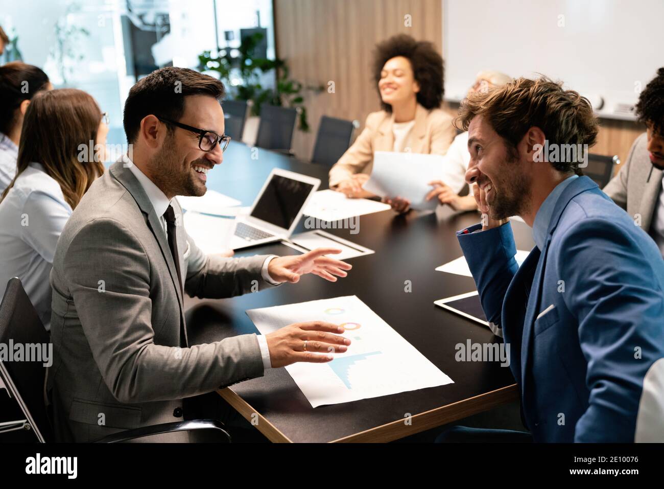 Happy diverse business colleagues meeting, working in modern office ...